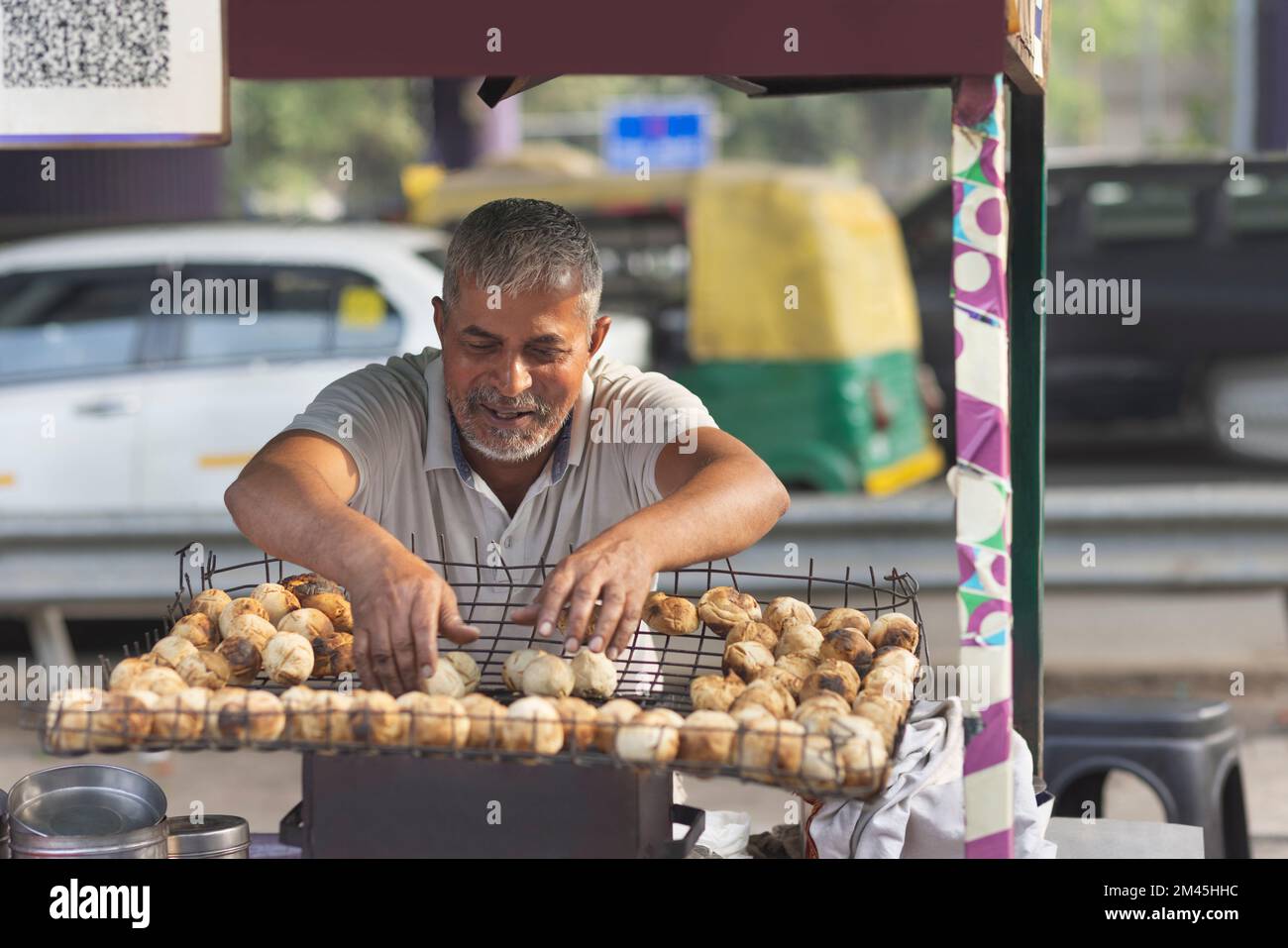 Male vendor making litti at his roadside food stall Stock Photo - Alamy