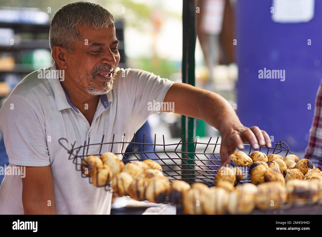 Male vendor making litti at his roadside food stall Stock Photo - Alamy