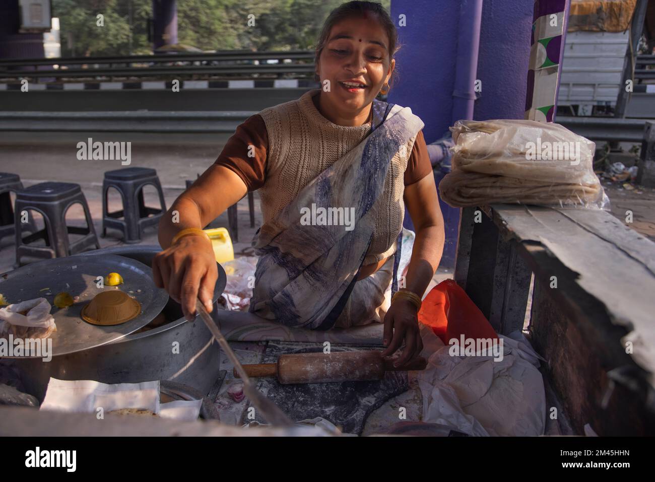 Portrait of a senior woman cooking at her roadside food stall Stock ...