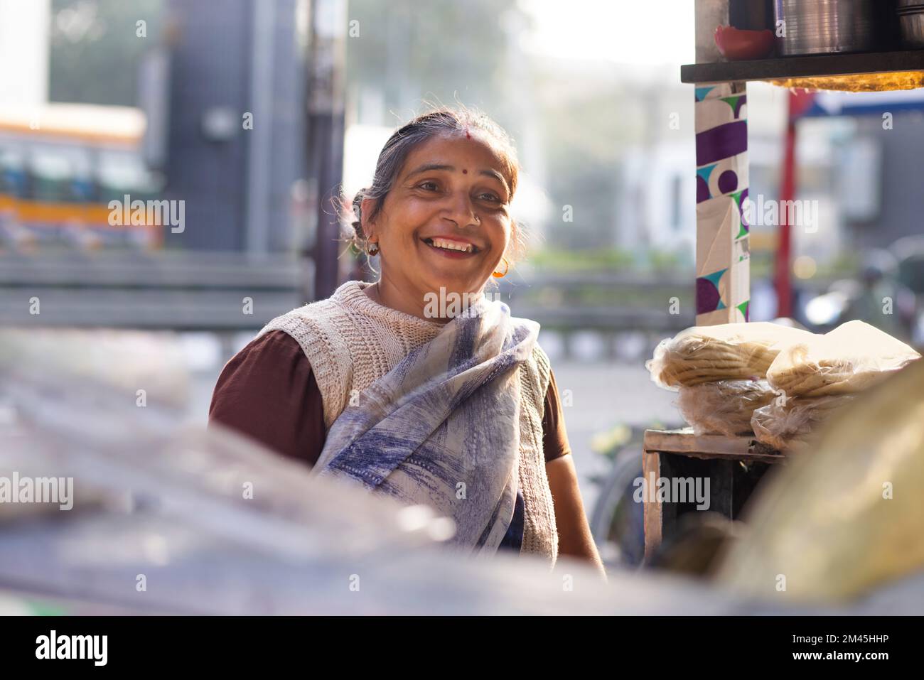 Portrait of a smiling female vendor at her roadside food stall Stock ...