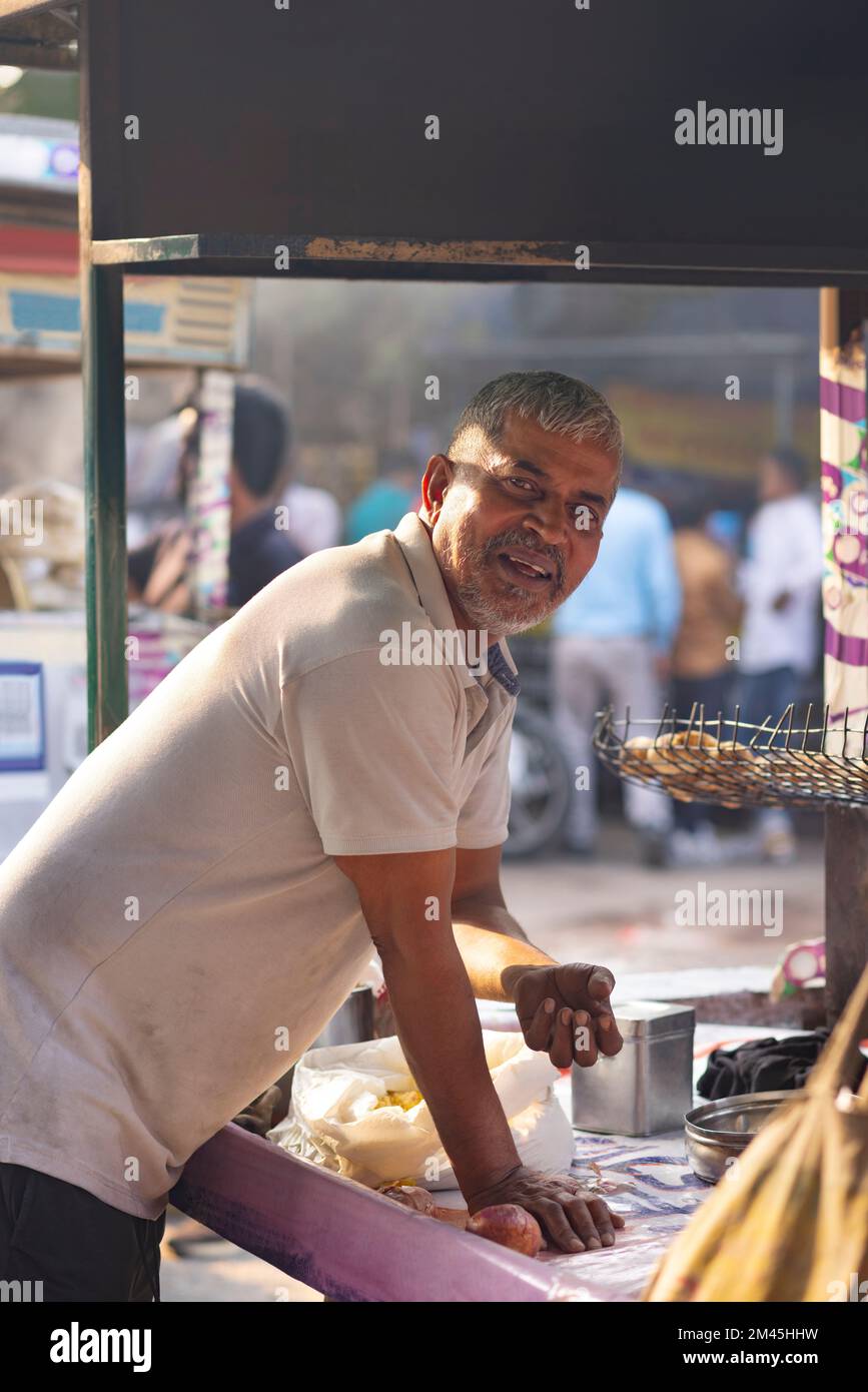 Portrait of male vendor looking at camera while standing at his ...