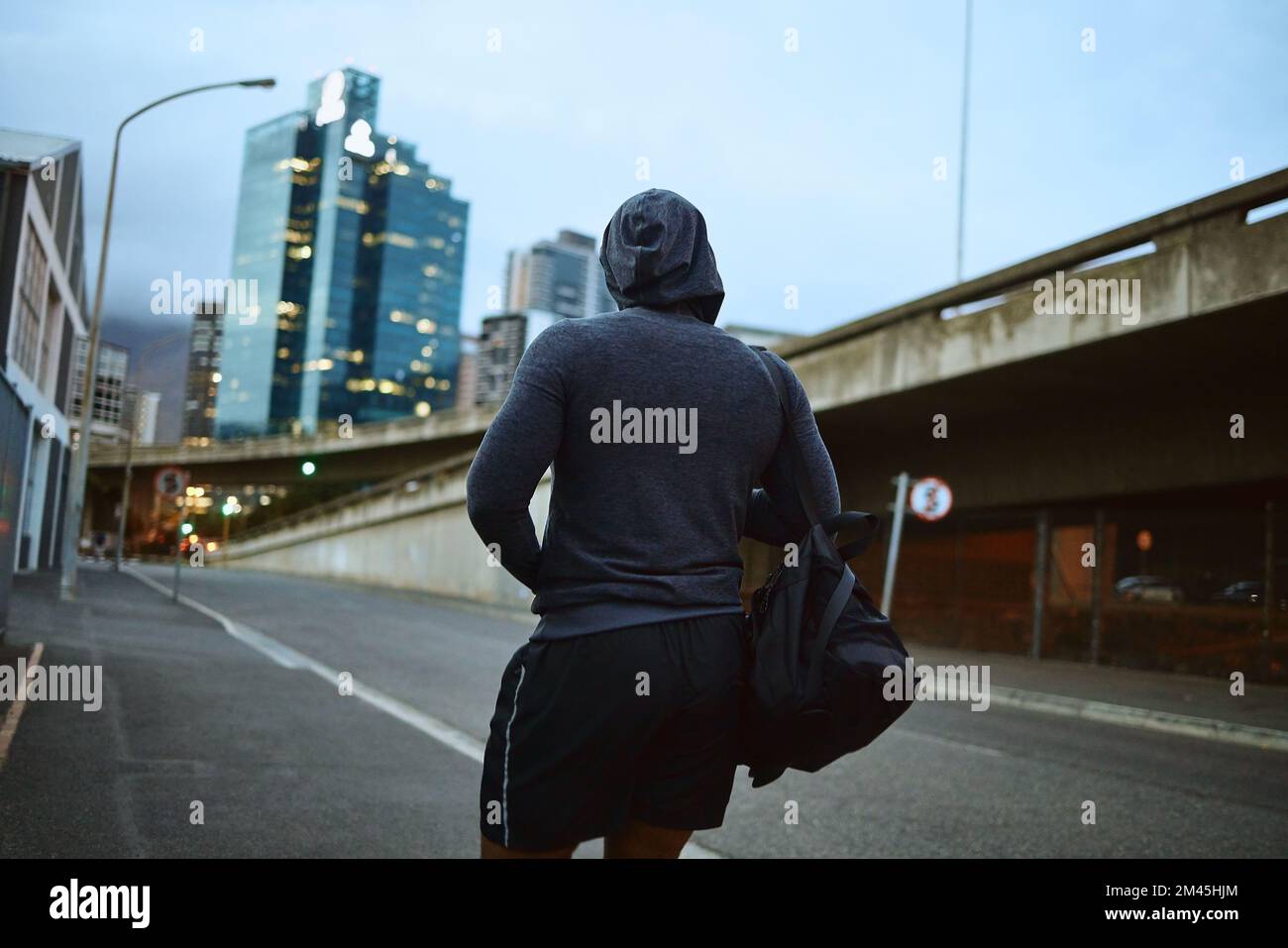 Fitness, running and city with a sports man walking on an asphalt road ...