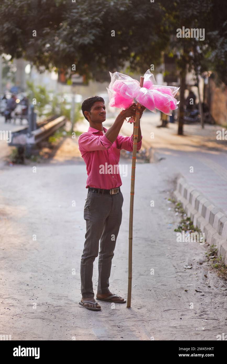 Male vendor selling cotton candy on the street Stock Photo - Alamy