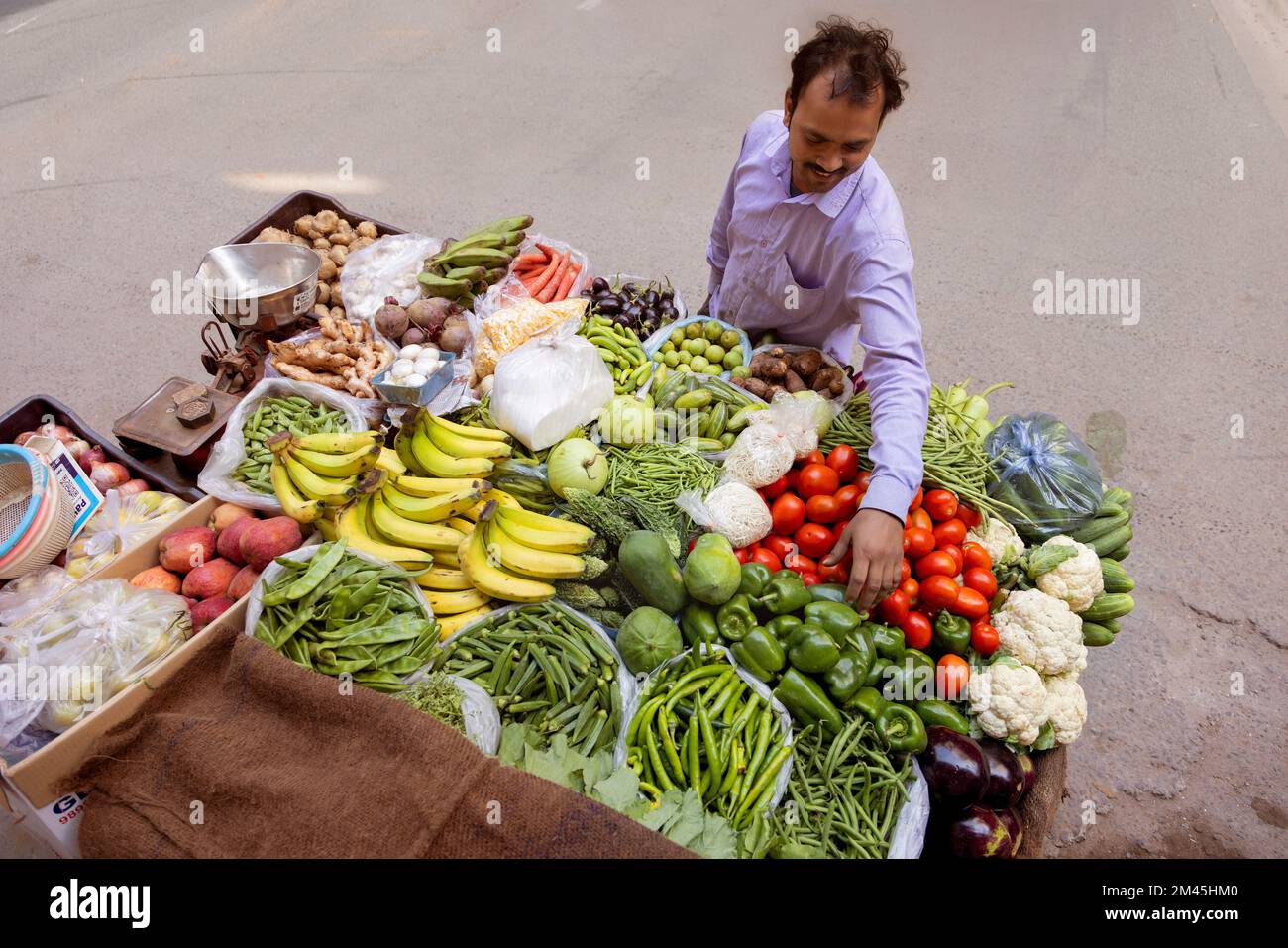 Male vendor selling vegetables at his roadside stall Stock Photo - Alamy