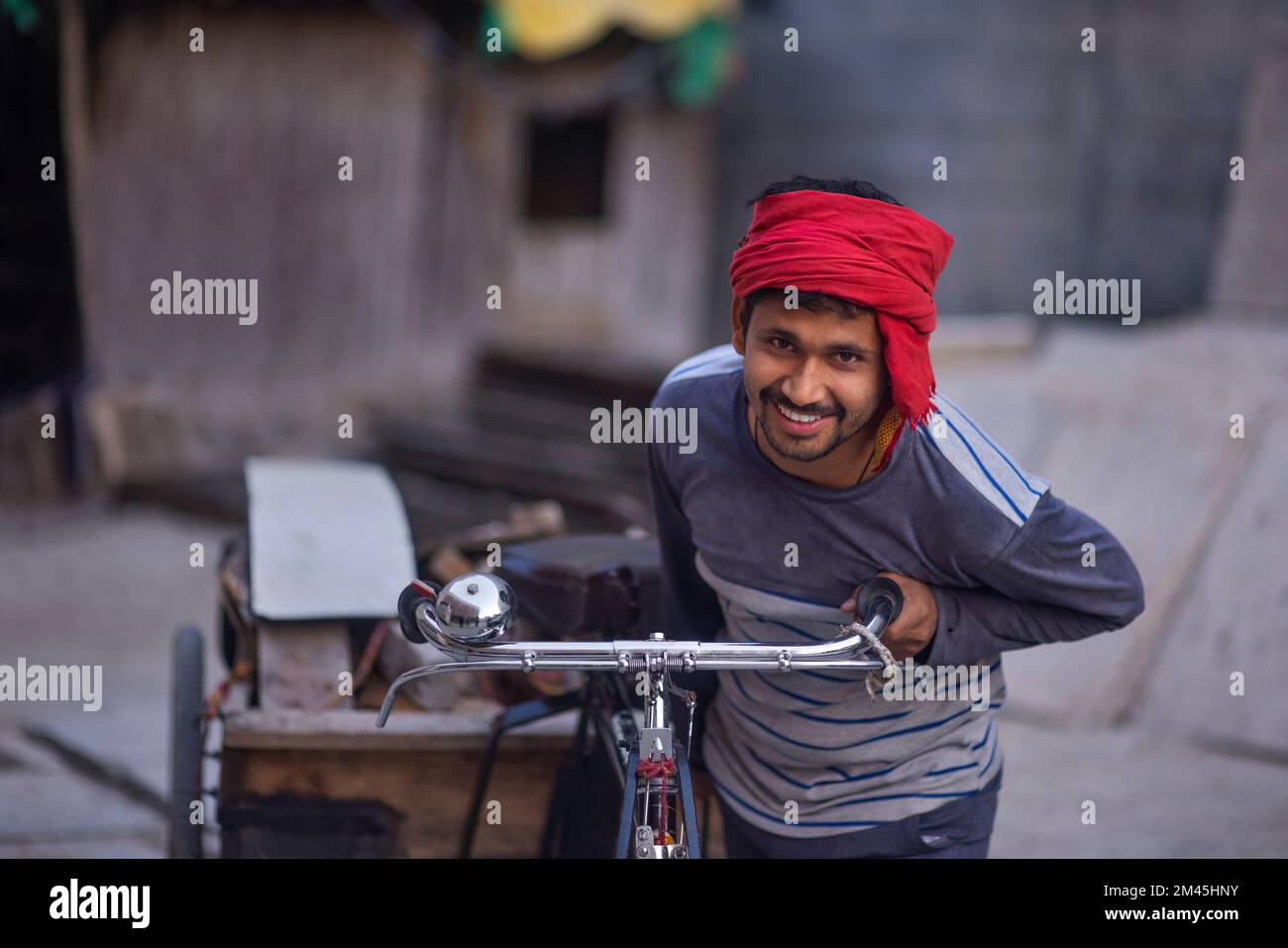 Portrait of a rickshaw puller with his rickshaw and his workload Stock ...