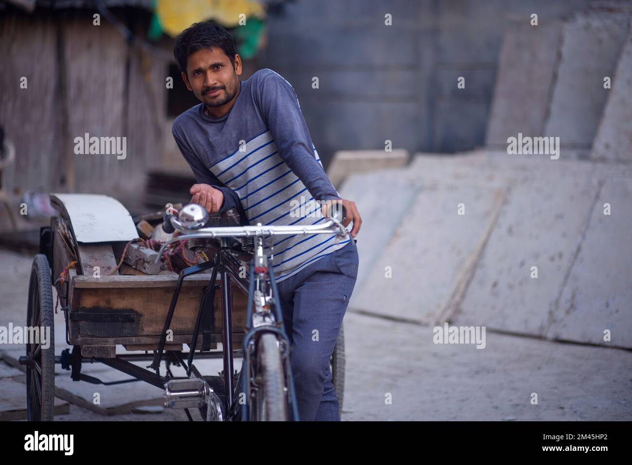 Portrait of a rickshaw puller with his rickshaw and his workload Stock ...