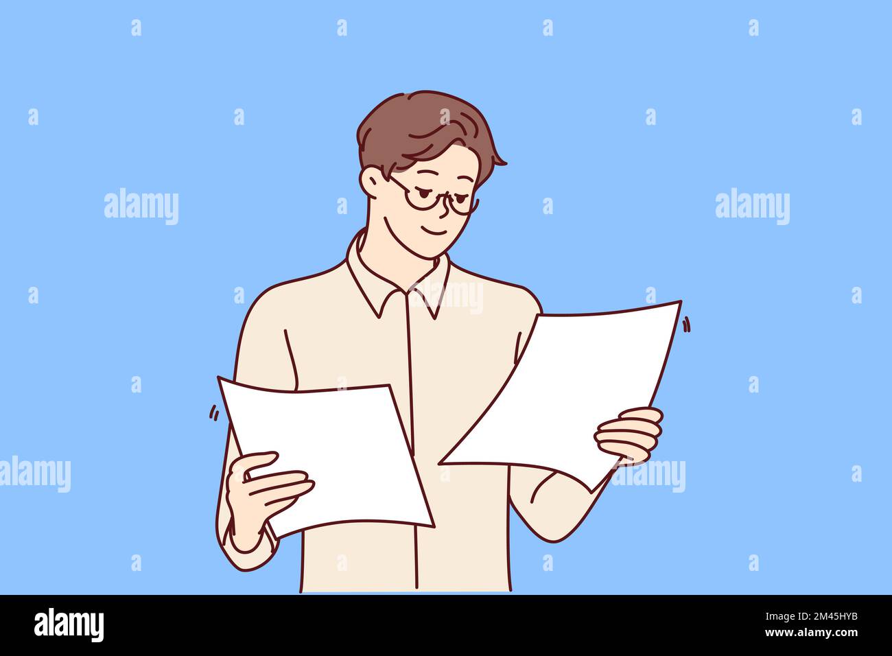 Concentrated man holding two sheets of paper in hands reading report ...