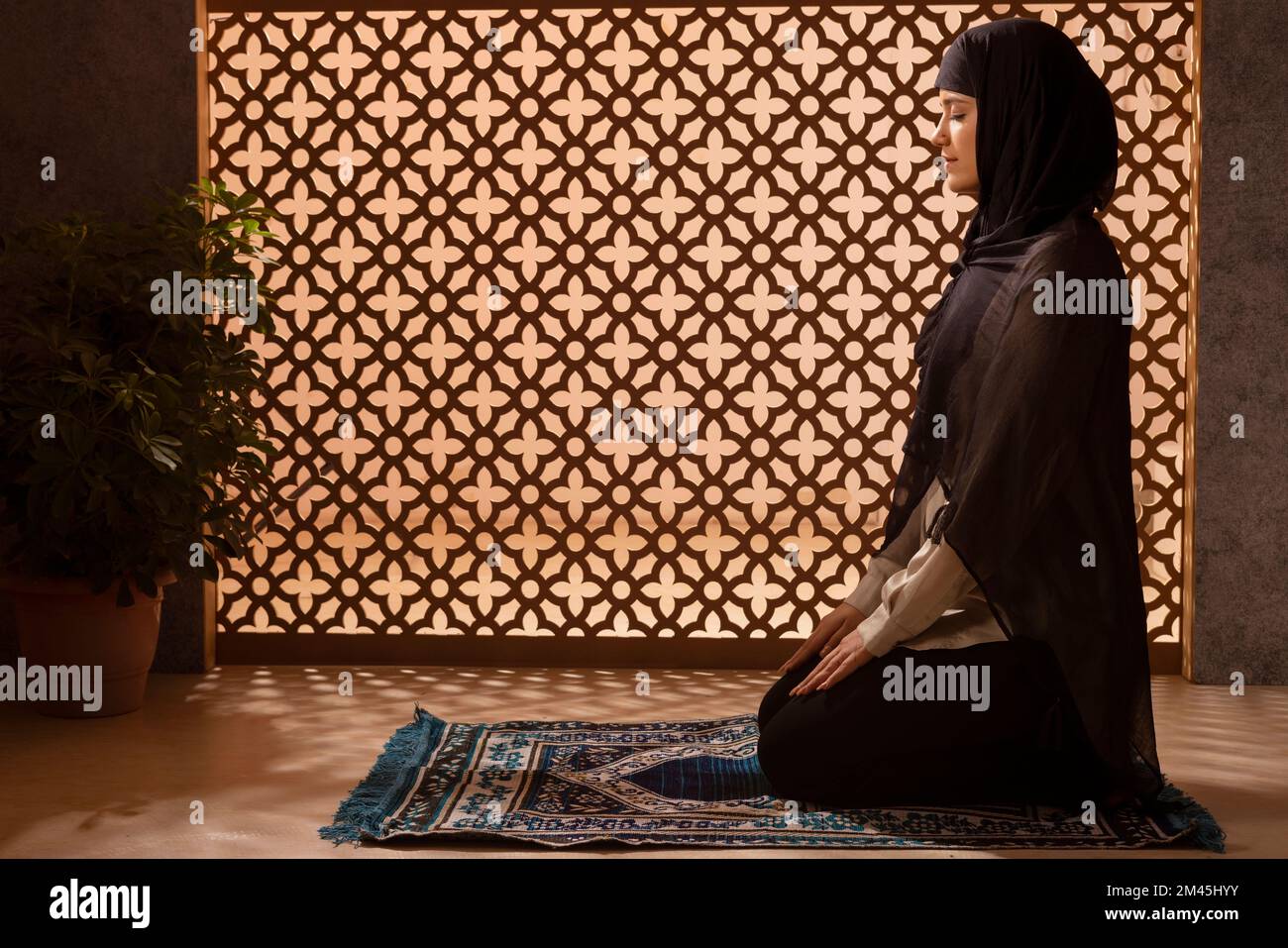 Portrait of a Muslim woman praying at home Stock Photo - Alamy