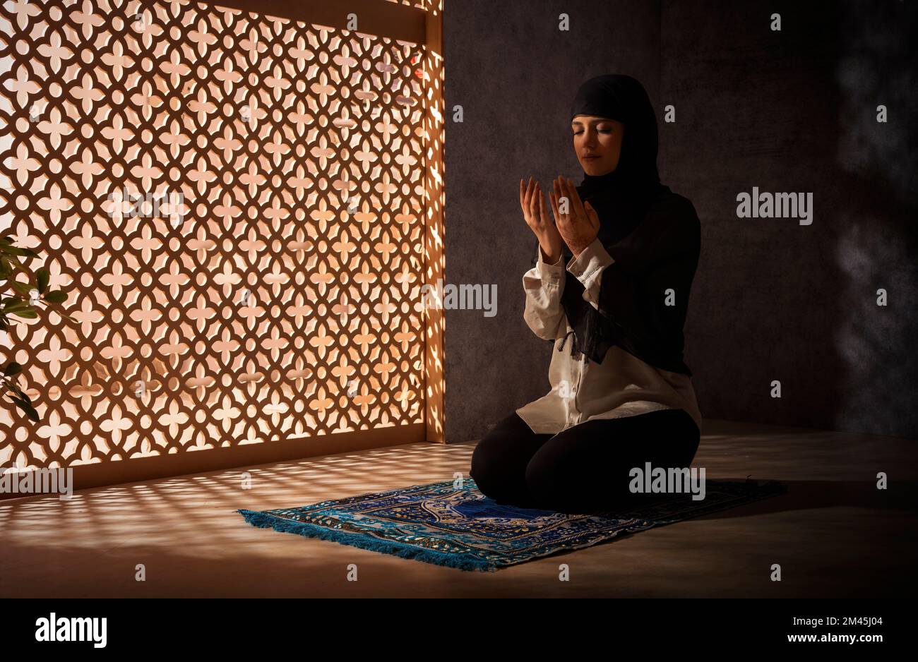 Portrait of a Muslim woman praying at home Stock Photo - Alamy