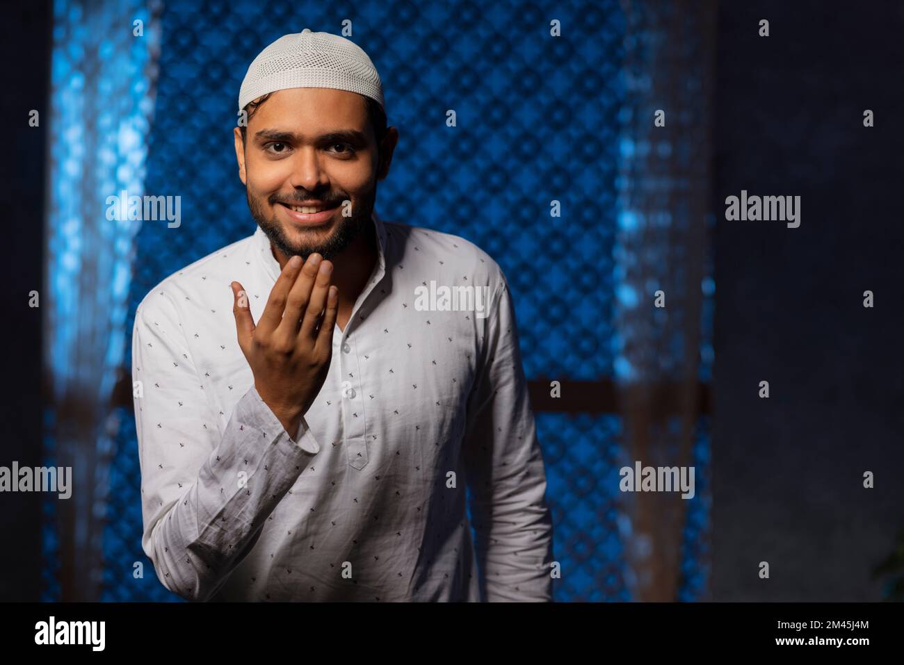 Portrait of a Muslim man greeting with adab Stock Photo - Alamy