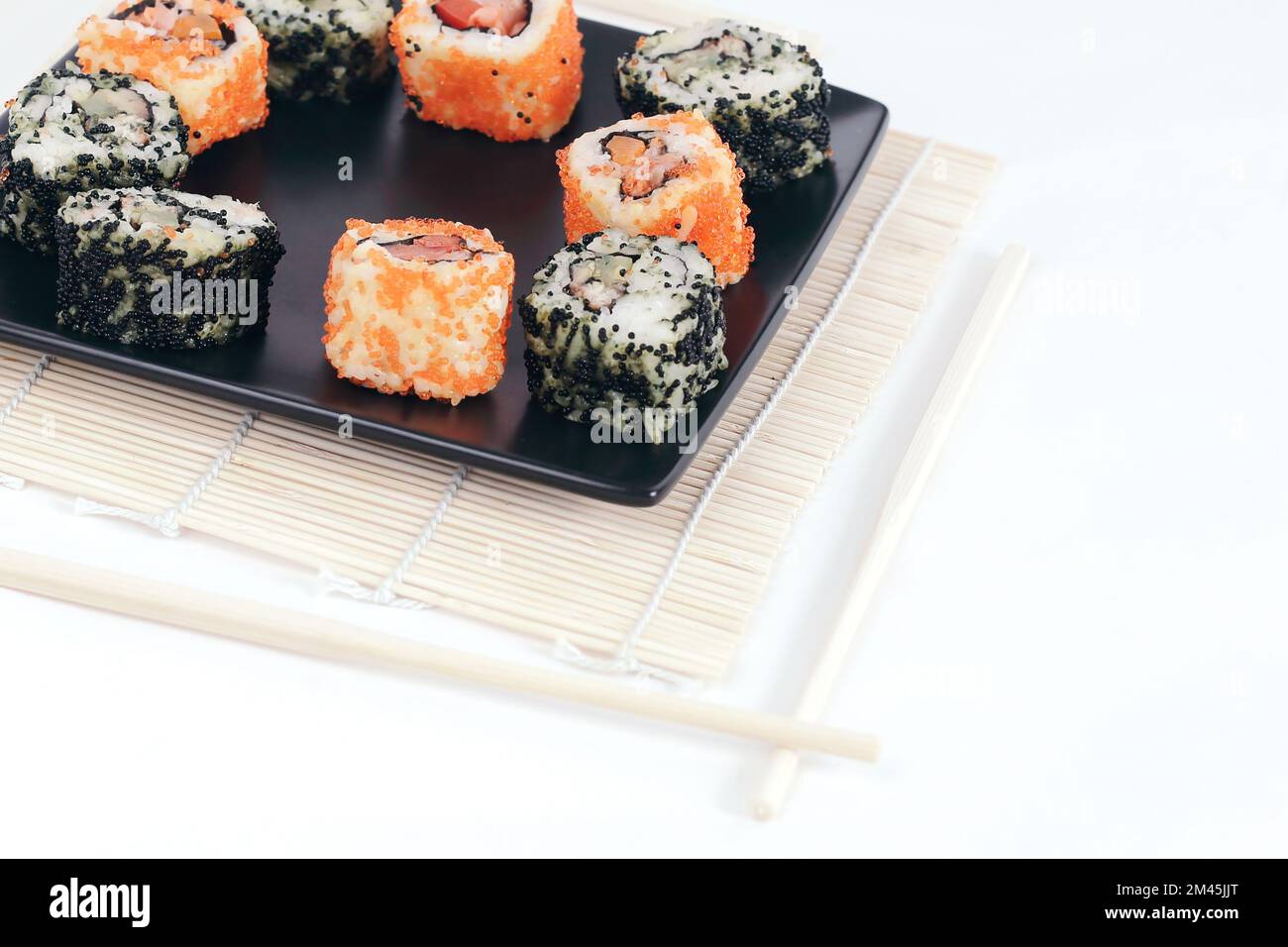 different types of Maki sushi on a black plate.isolated on white ...