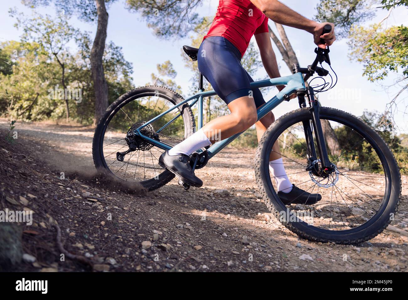 legs of a cyclist drifting on his mountain bike Stock Photo - Alamy