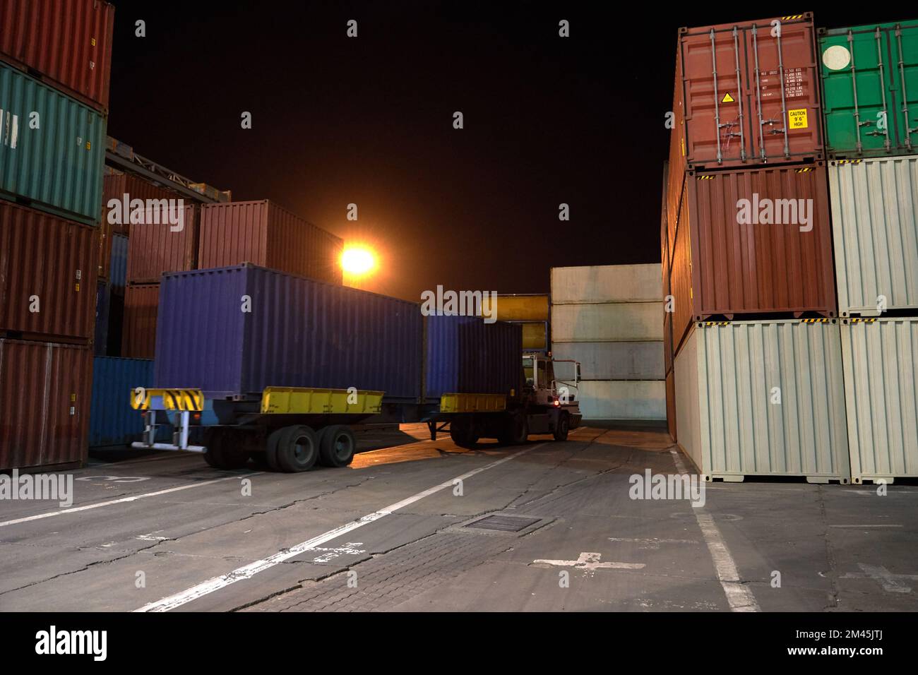 operation of container terminal at night. Unloading container ship at ...