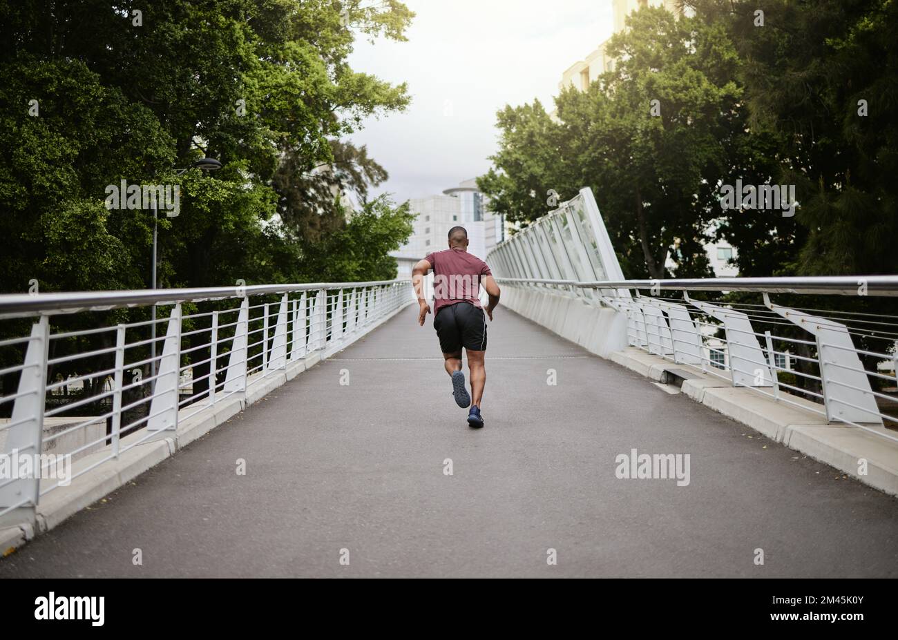 Fitness, man and running in the city park for healthy exercise, cardio ...