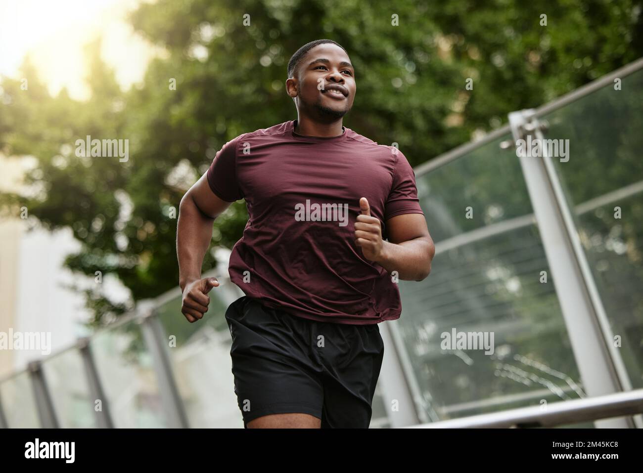 Black man, fitness and running in park for healthy workout, exercise or ...