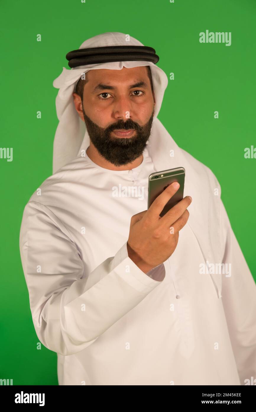 Emirati man using mobile phone Stock Photo - Alamy