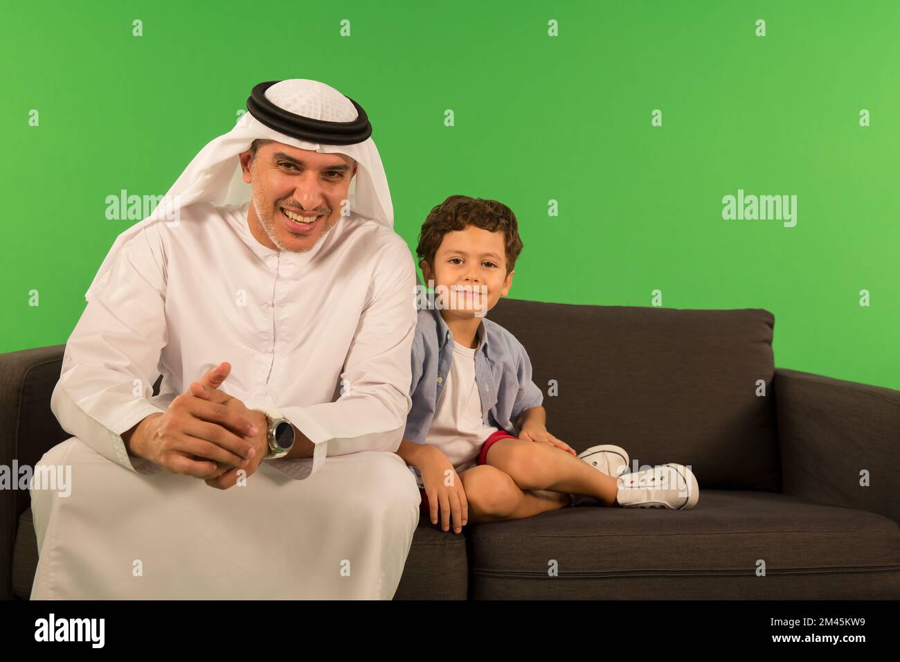Emirati father with son playing video game Stock Photo - Alamy