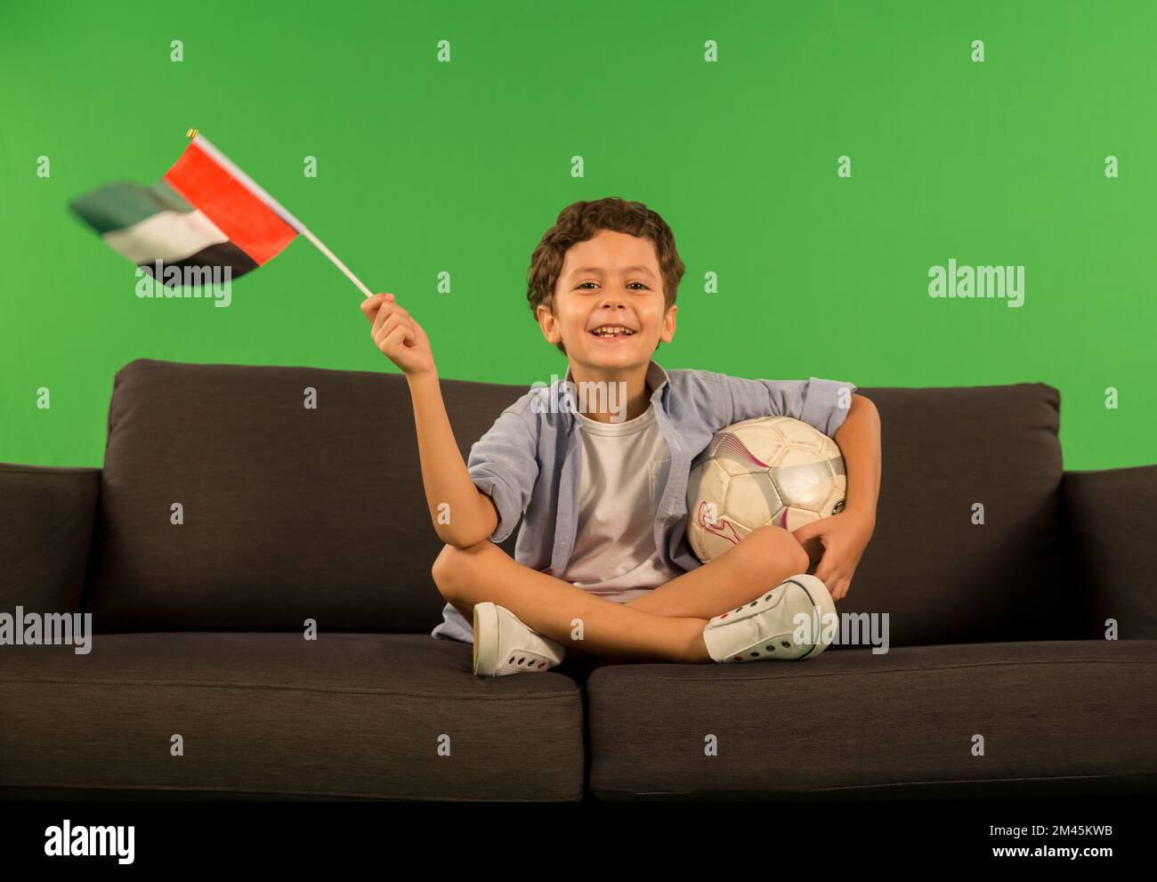 Boy holding a ball and the UAE National flag Stock Photo - Alamy
