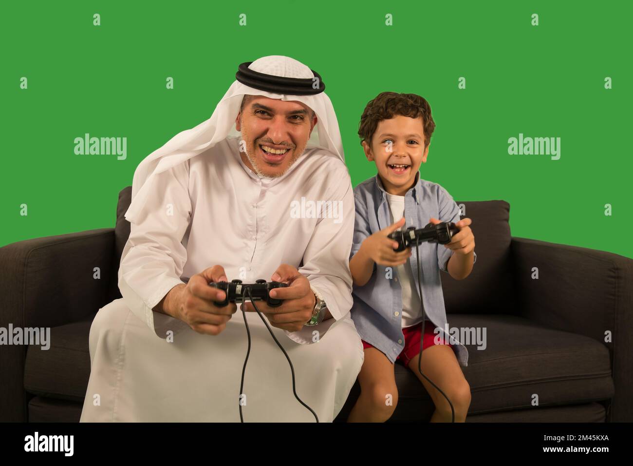 Emirati father with son playing video game Stock Photo - Alamy