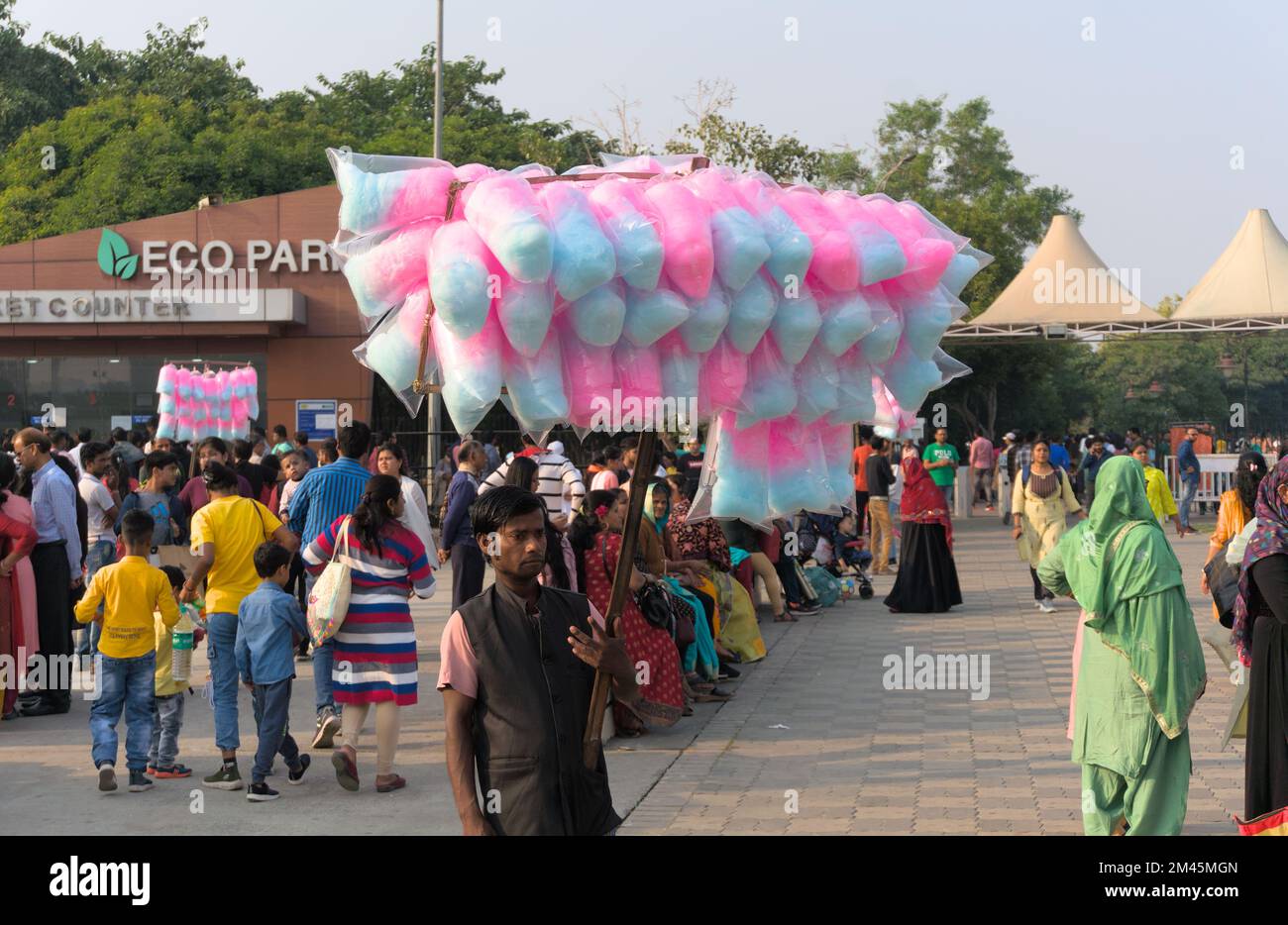 Visitors gathered at amusement park ticket counter on sunny winter ...