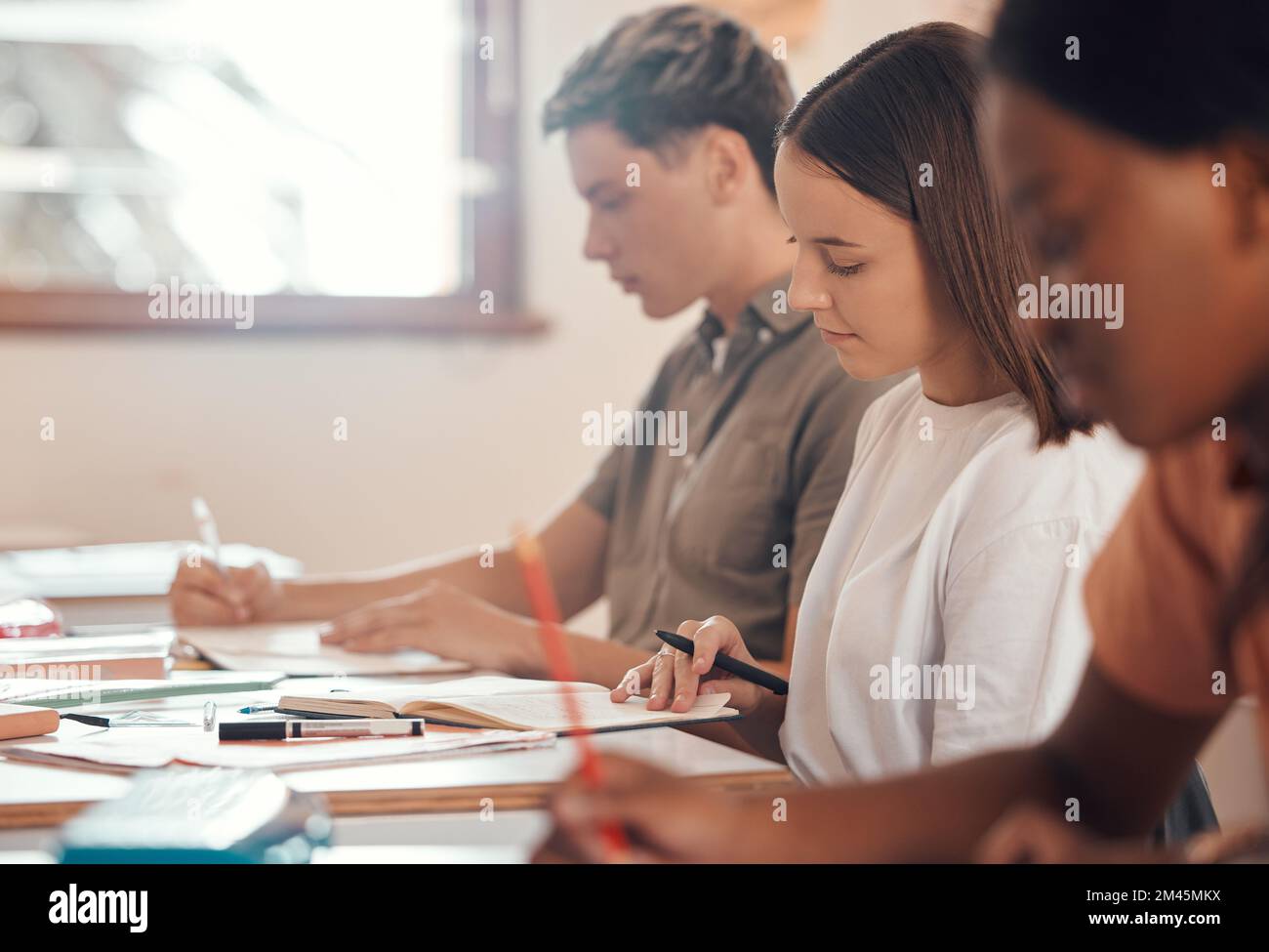 Education, writing and exam with students in classroom of college for ...
