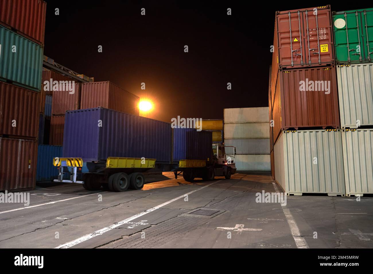 operation of container terminal at night. Unloading container ship at ...