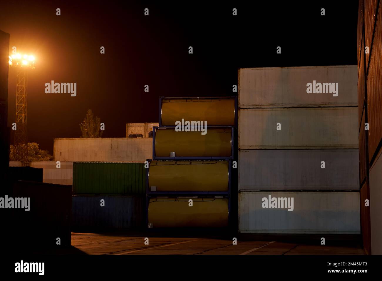 operation of container terminal at night. Unloading container ship at ...