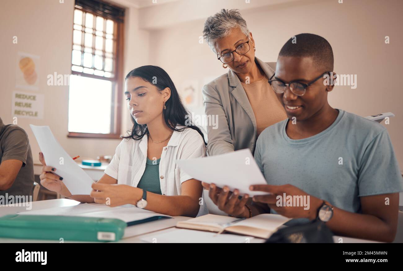 Student, exam and woman teacher with students in a school education ...