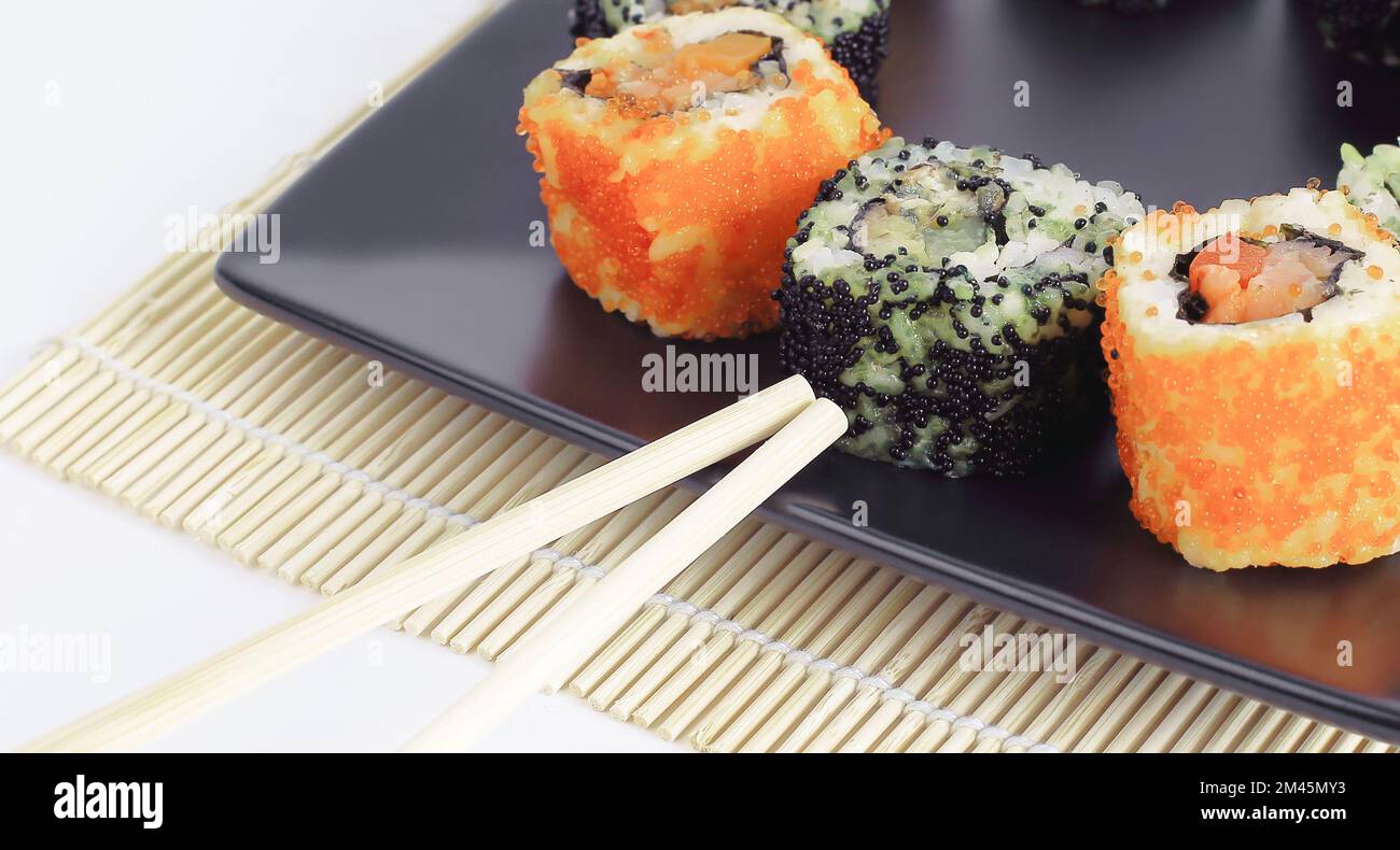 Sushi Set - different types of Maki sushi and chopsticks on a b Stock ...