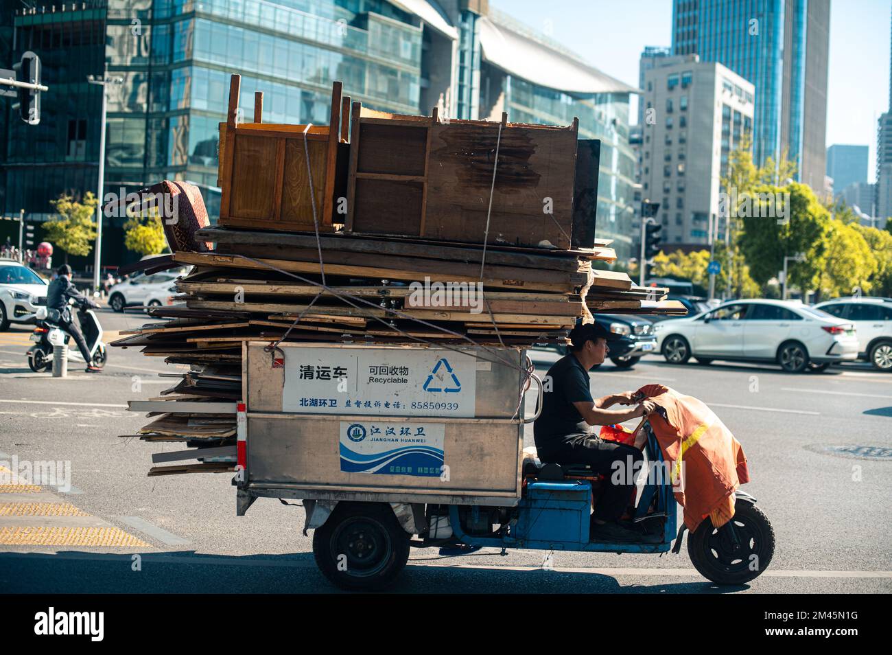 A sanitation worker transporting waste furniture Stock Photo - Alamy