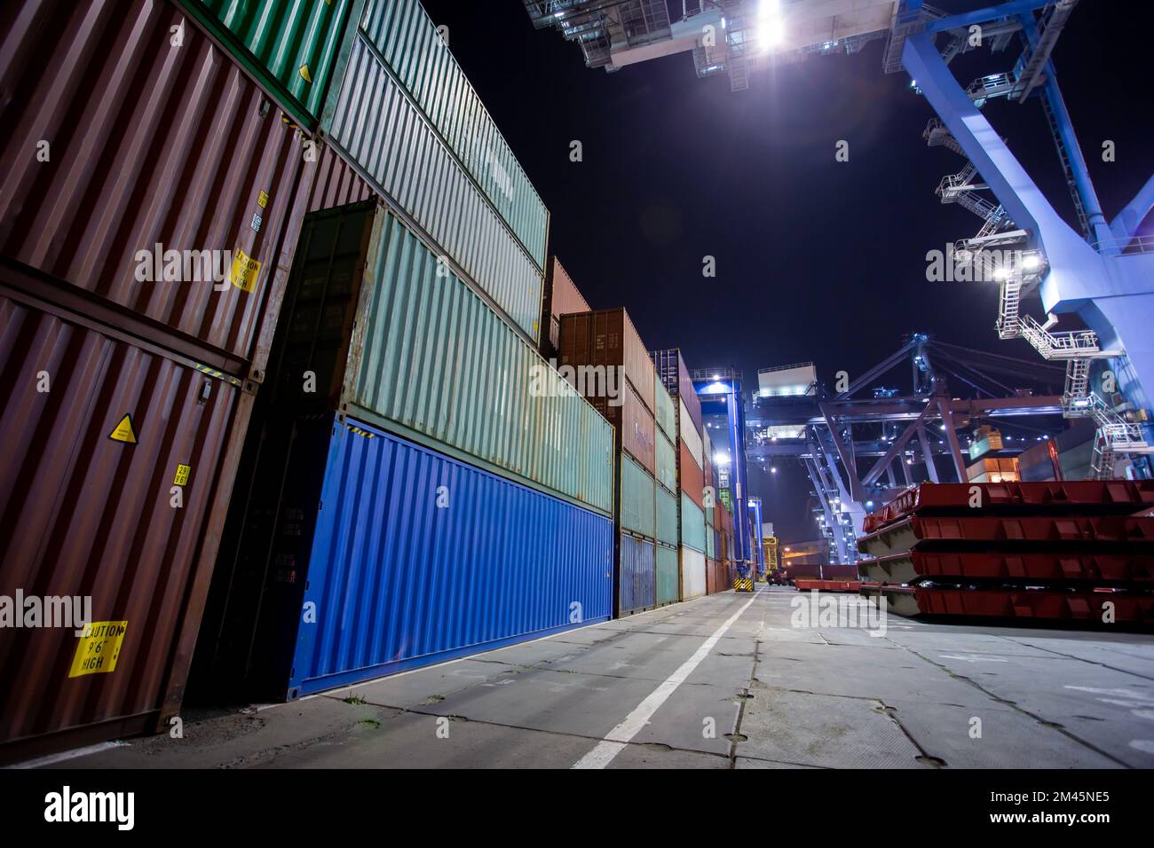 stacks of containers. operation of container terminal at night ...