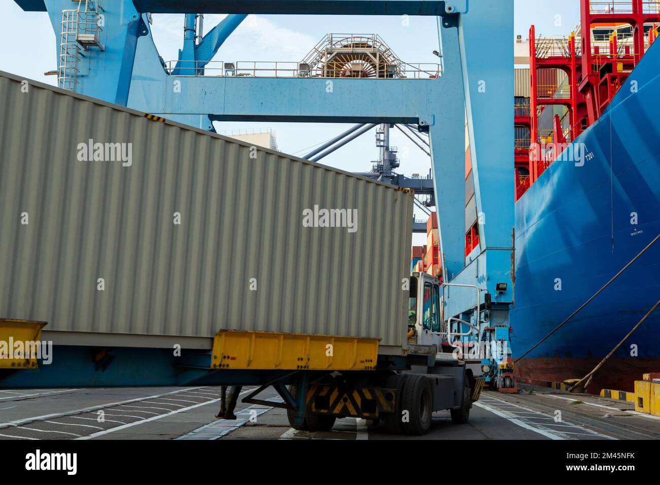 Port container terminal with container ship in background and white ...