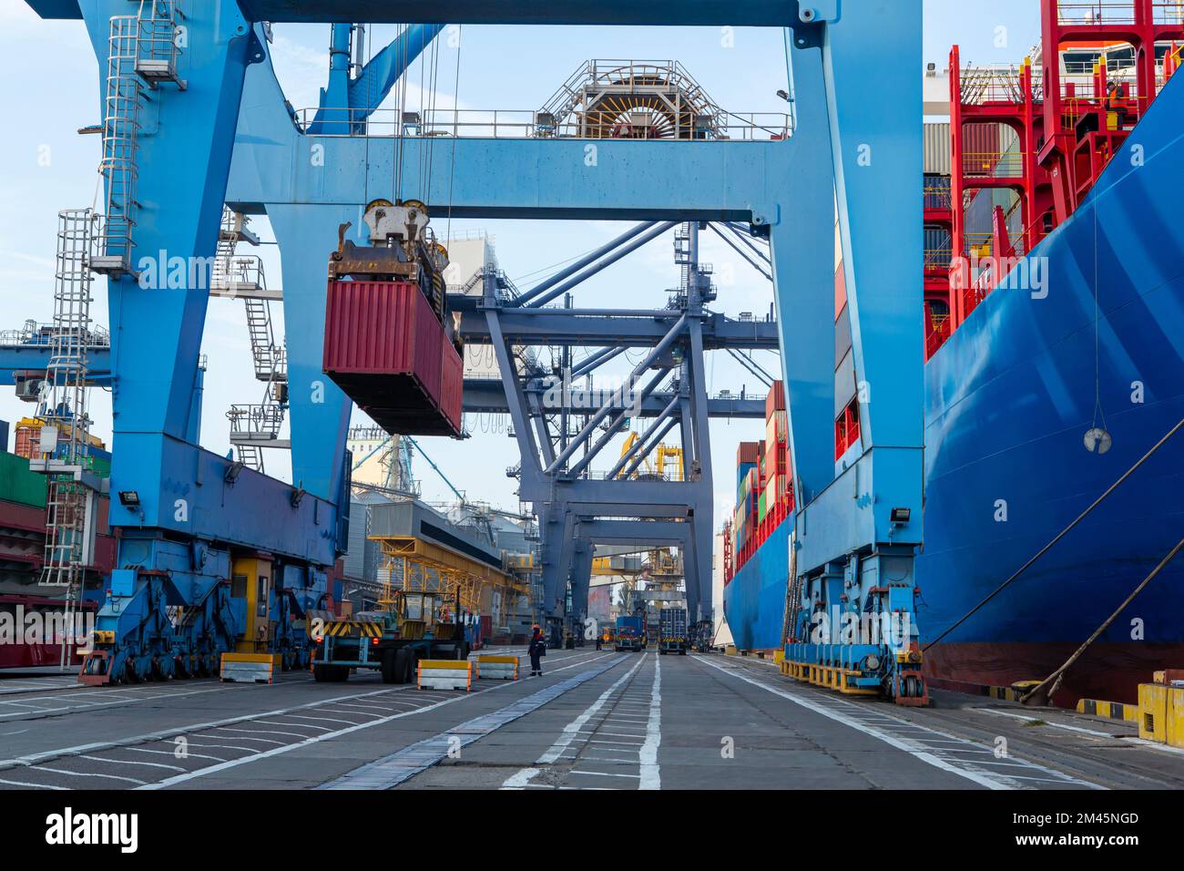 Container port with container ship. berthing crane loads container onto ...