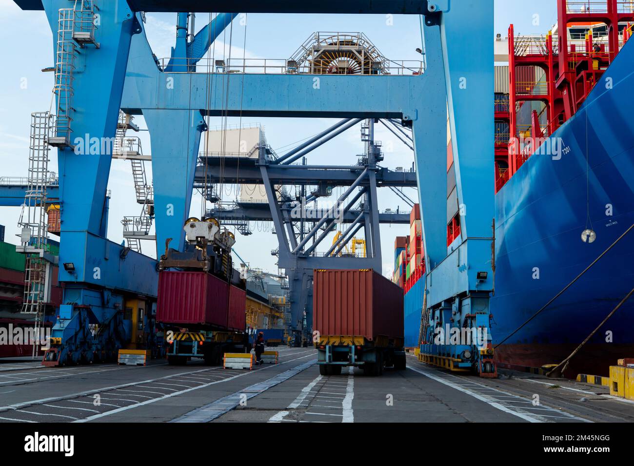 Container port with container ship. berthing crane loads container onto ...