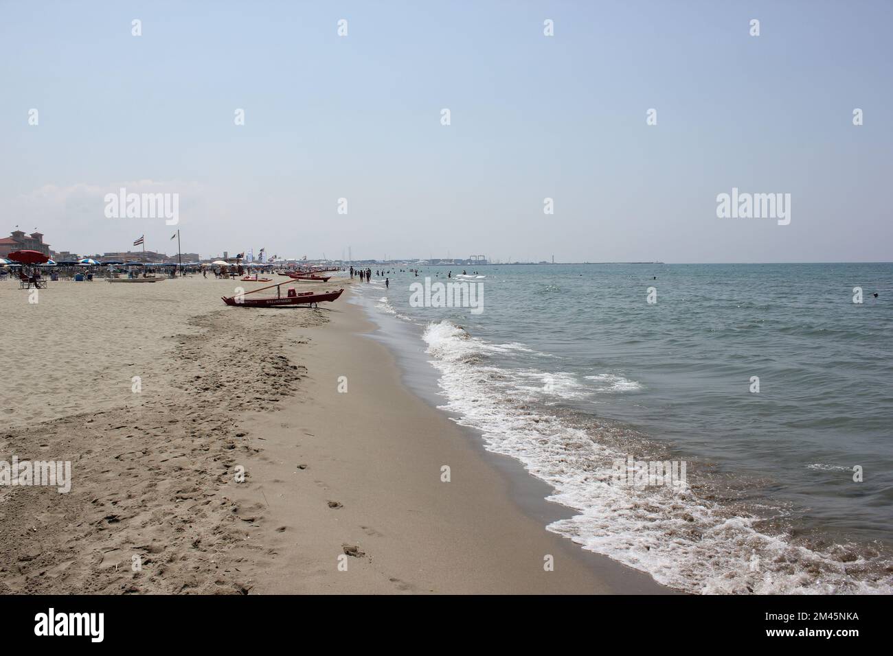 Empty Indian Ocean shore with a single fisherman boat, sandy beach ...