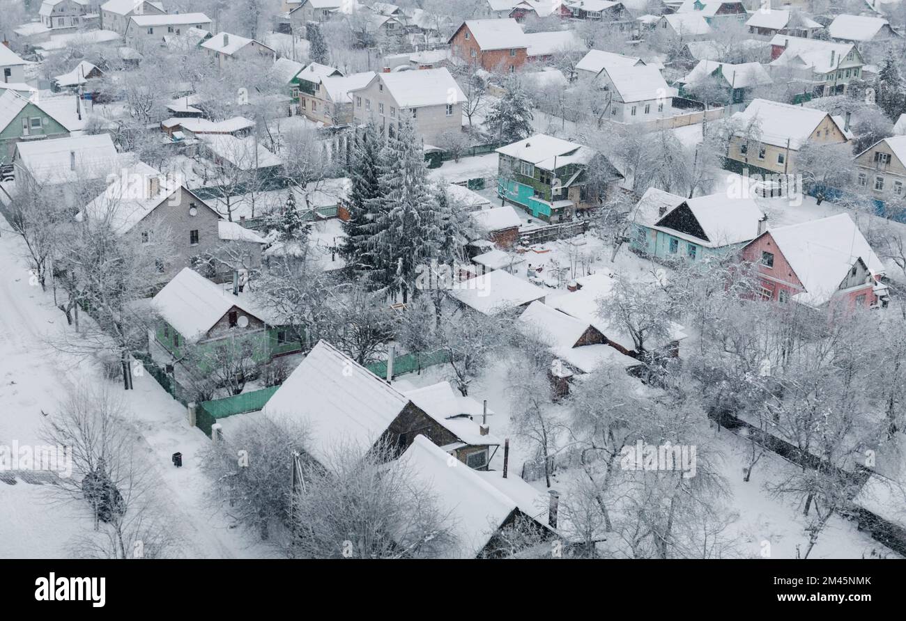 Aerial. Townhouse in winter. Snow covered rooftops of cottages. Top ...