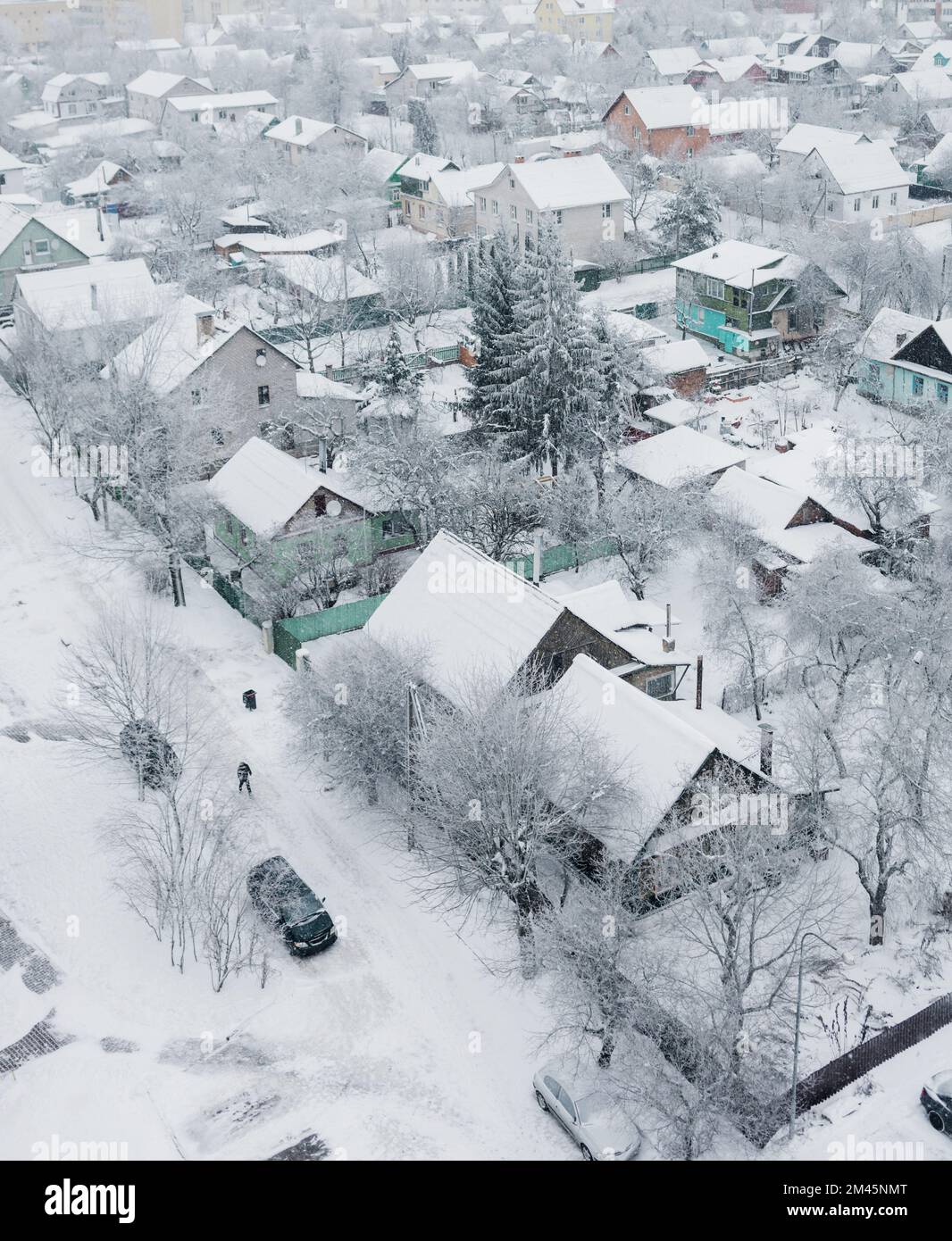 Aerial. Buildings in winter. Snow covered rooftops of houses. Top view ...