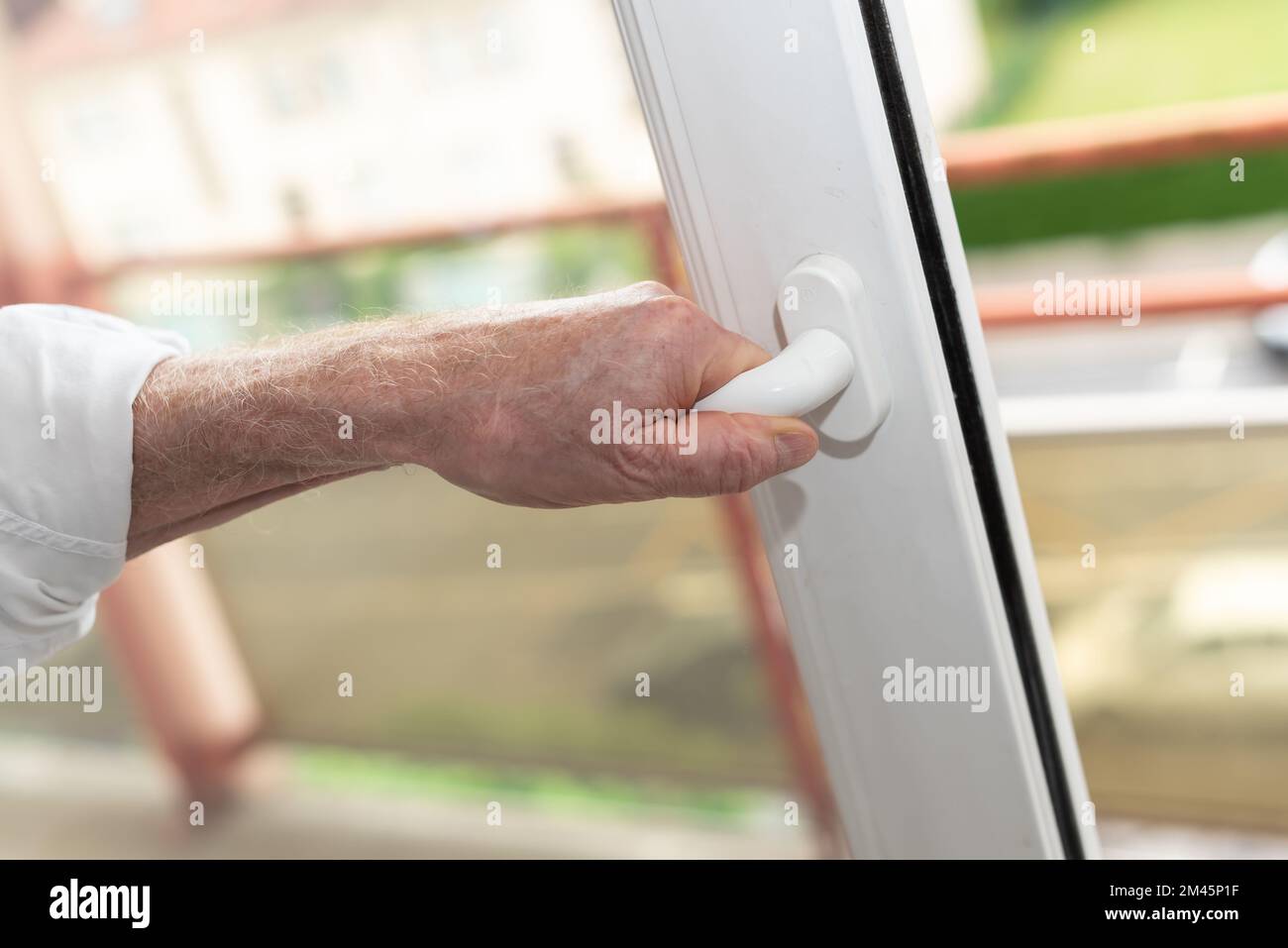 Male hand opening a window Stock Photo - Alamy