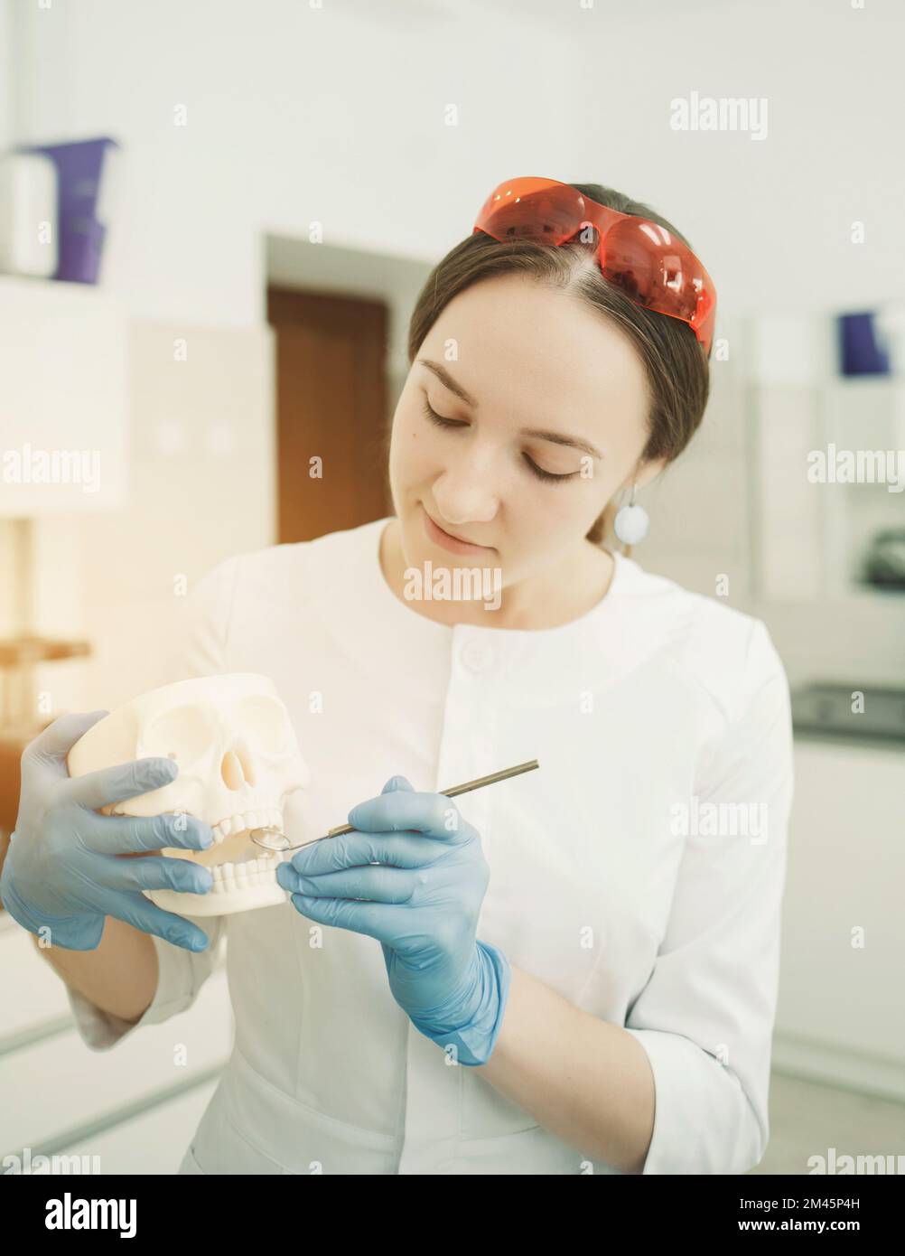 Dentistry. Dentist with tool checks in teeth Stock Photo - Alamy