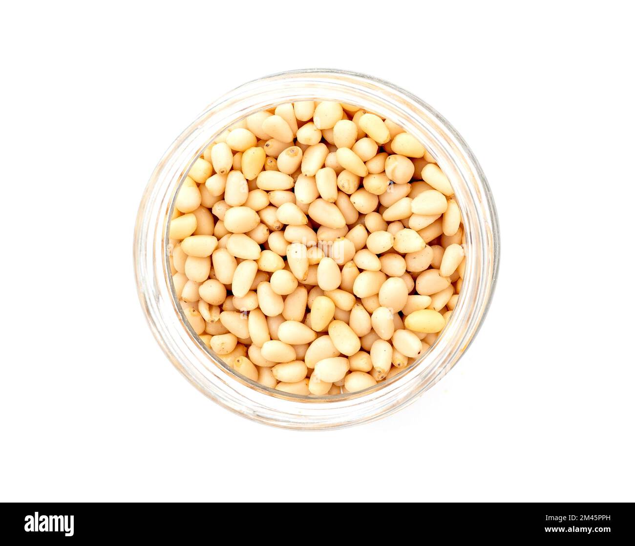Prepared cedar pine nuts in round glass can isolated on white, top view ...
