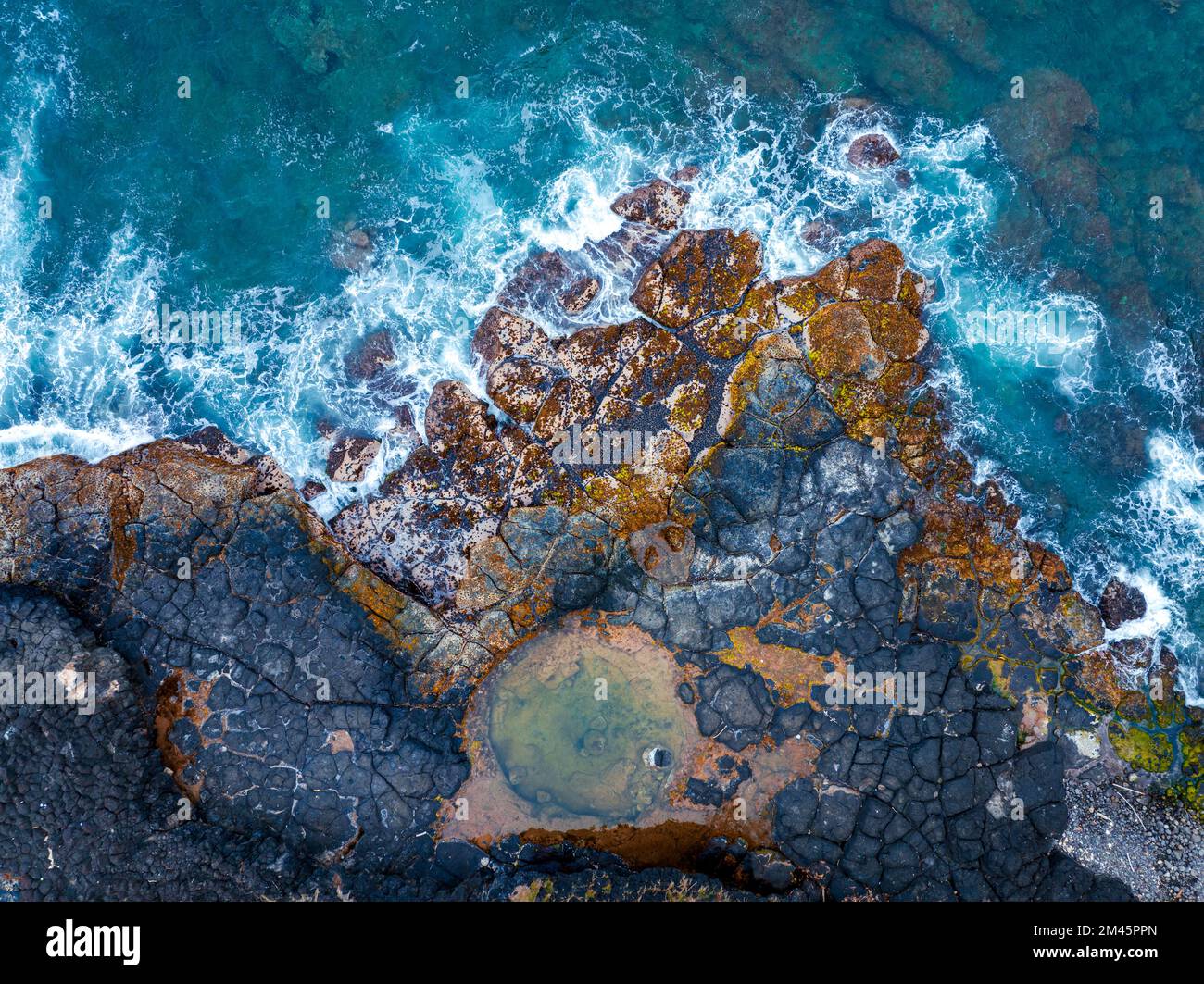 Amazing black rocks on the coastline. Breaking waves on the cliffs ...