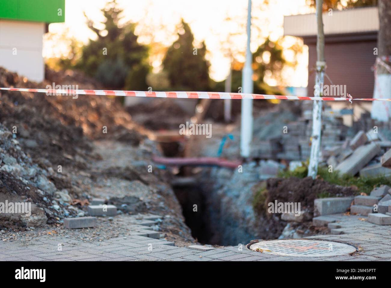 Repair of sewer system on street. Dug-out put, stacked tables and ...