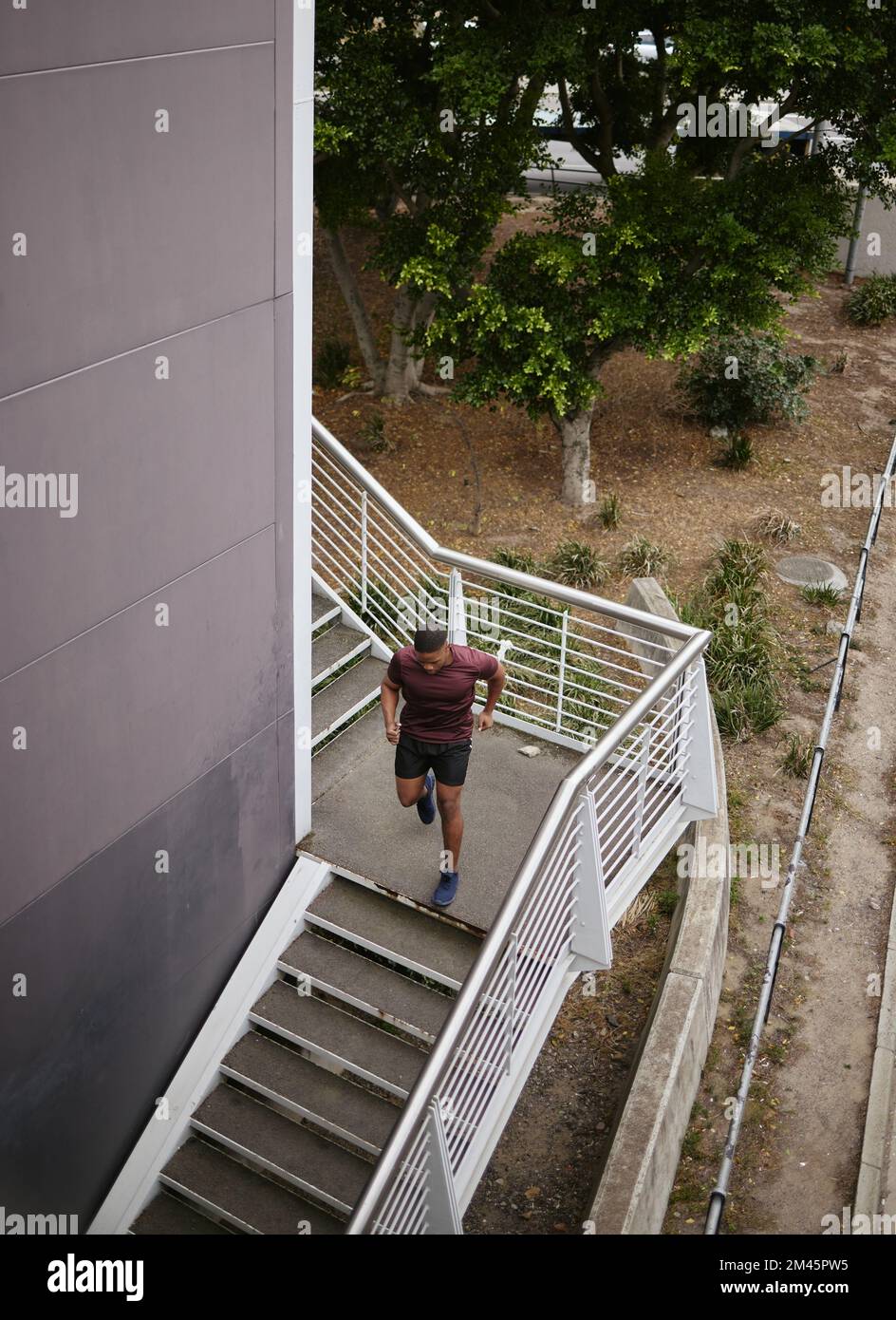 Running, fitness and training with man on stairs for sports, workout ...