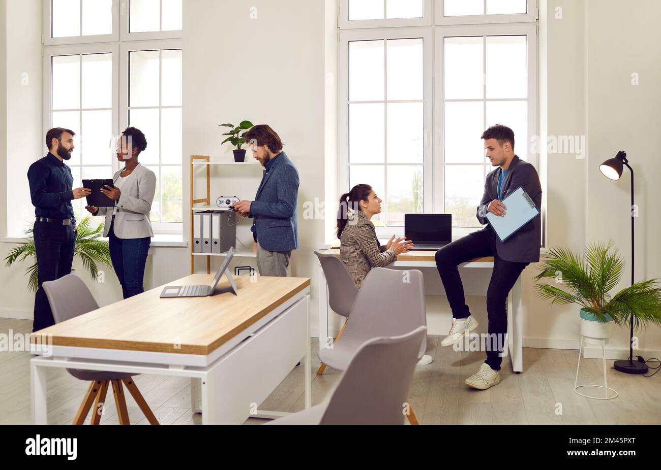 Diverse corporate business employees meeting and working in their ...