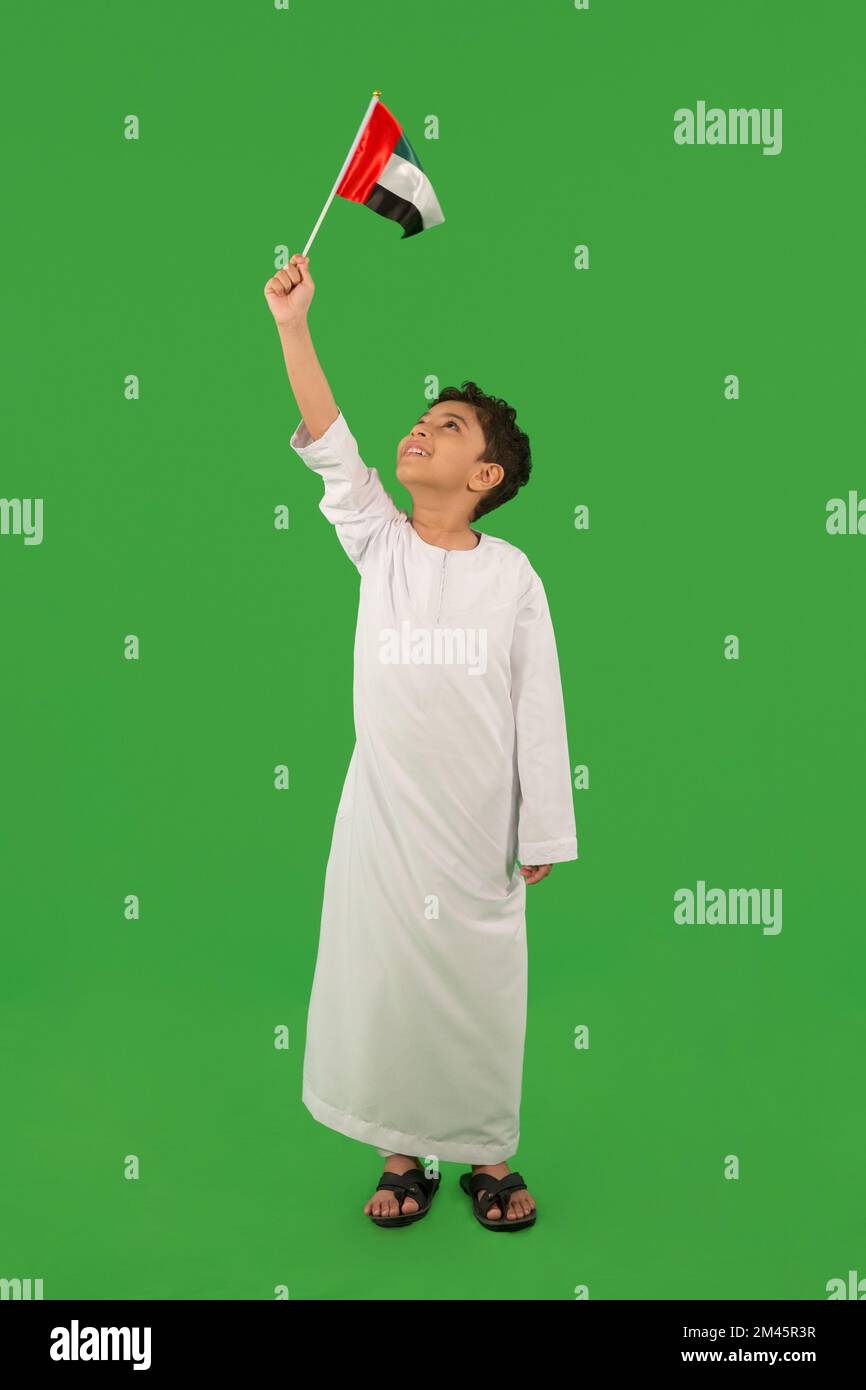 Portrait of an Arab boy holding a UAE national flag Stock Photo - Alamy