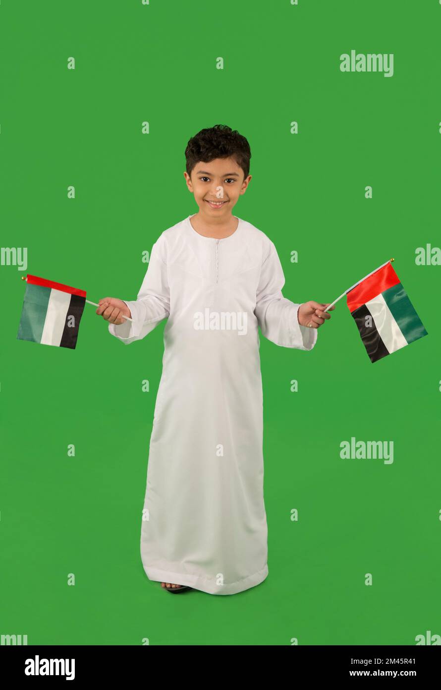 Portrait of an Arab boy holding a UAE national flag Stock Photo - Alamy