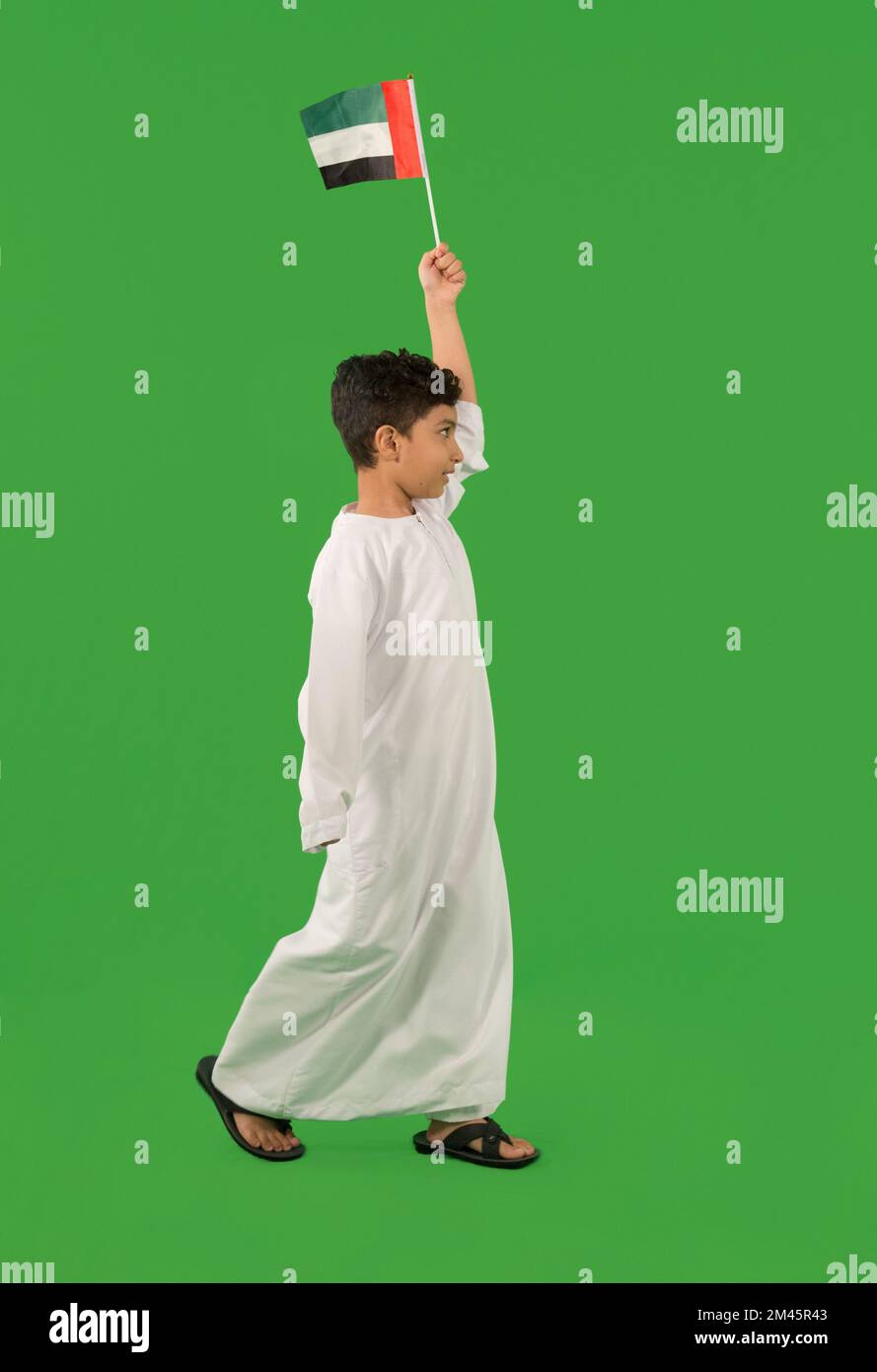 Portrait of an Arab boy holding a UAE national flag Stock Photo - Alamy