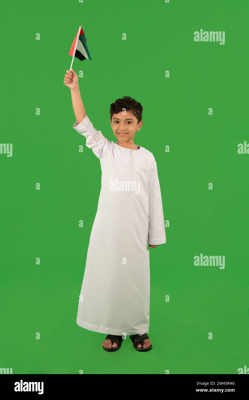 Portrait of an Arab boy holding a UAE national flag Stock Photo - Alamy