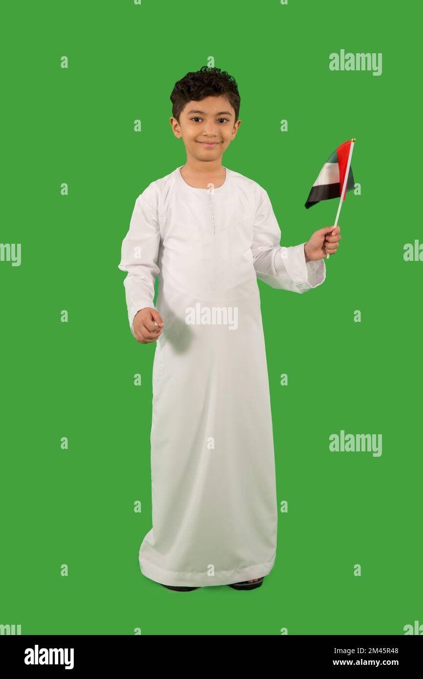 Portrait of an Arab boy holding a UAE national flag Stock Photo - Alamy