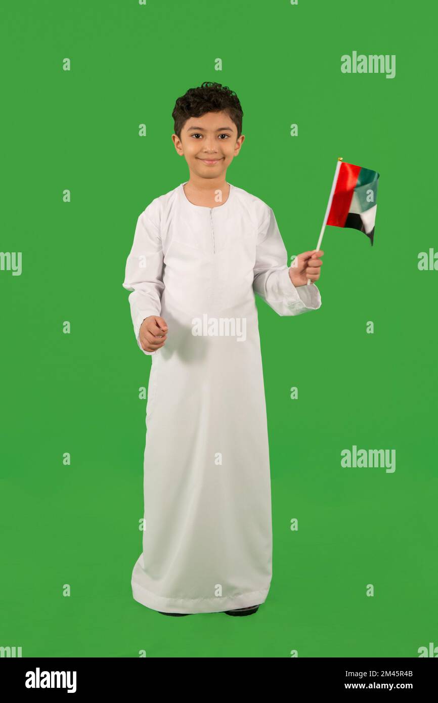 Portrait of an Arab boy holding a UAE national flag Stock Photo - Alamy